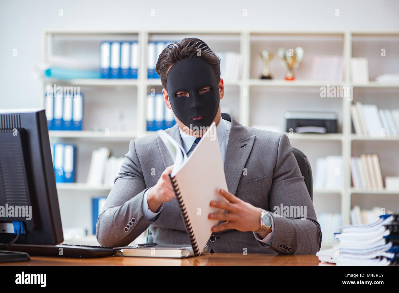 Businessman with mask in office hypocrisy concept Stock Photo - Alamy