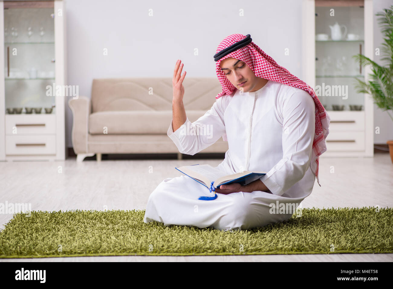 Arab man praying at home Stock Photo - Alamy