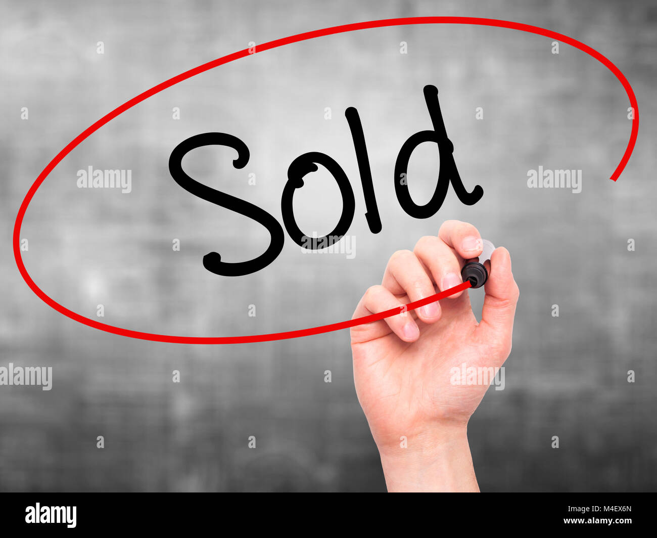 Man Hand writing Sold with black marker on visual screen Stock Photo ...