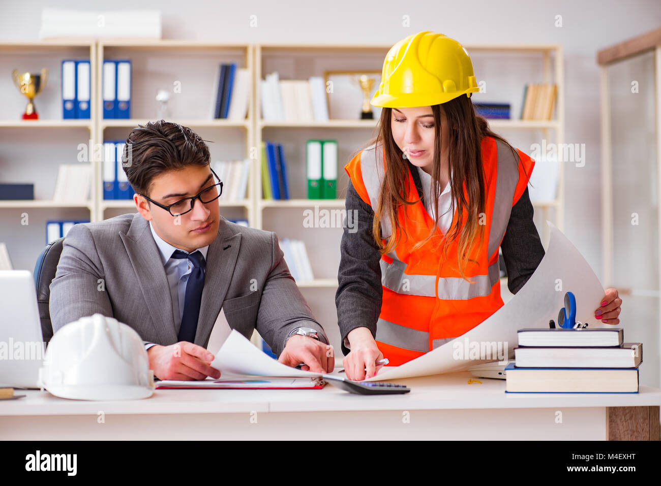 Reviewing architectural drawings hi-res stock photography and images ...