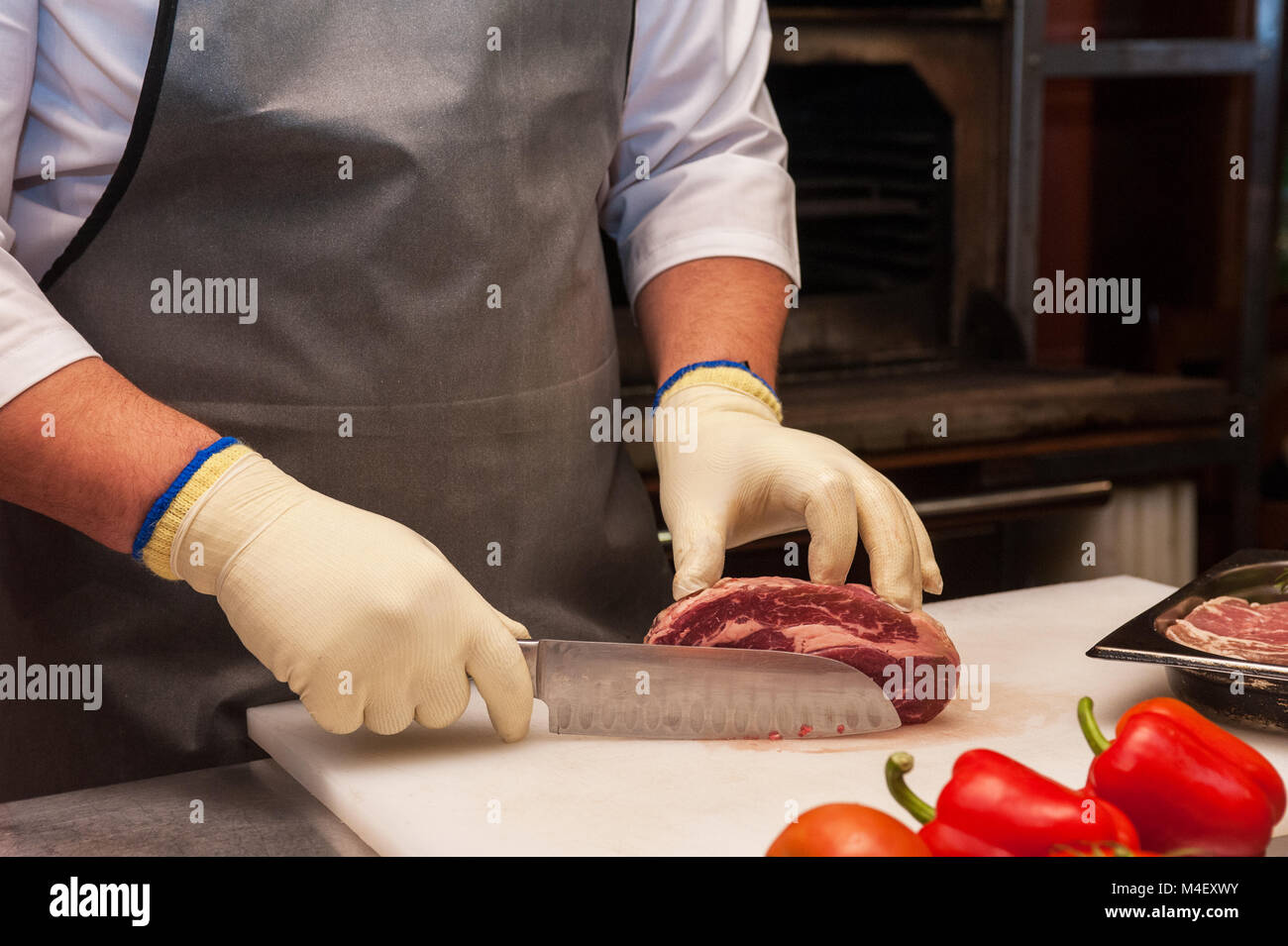 Chef cutting meat Stock Photo - Alamy