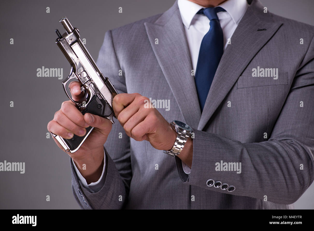 Pulling gun out of suit hi-res stock photography and images - Alamy