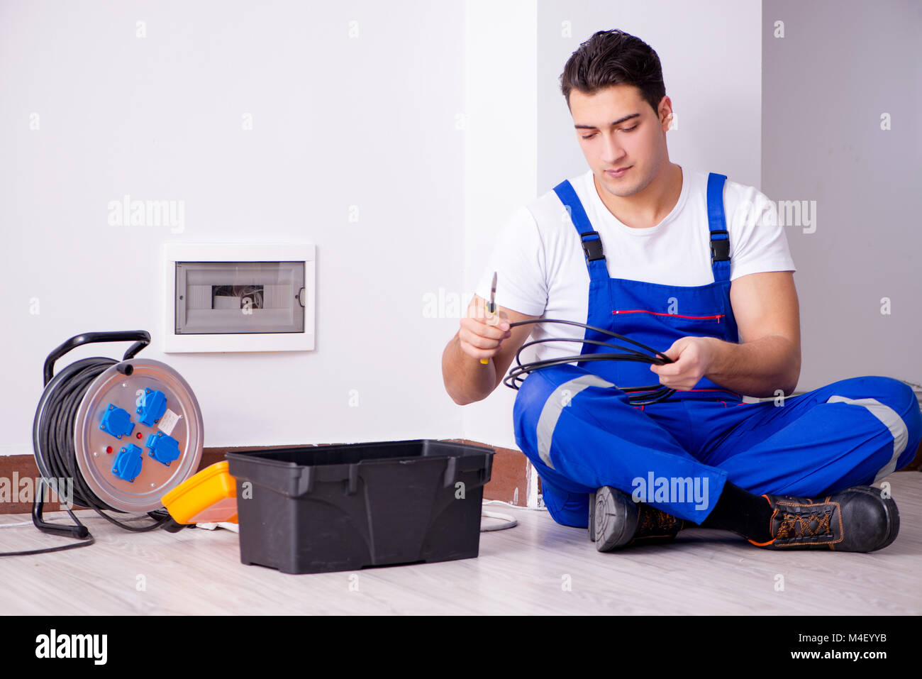 Man doing electrical repairs at home Stock Photo - Alamy