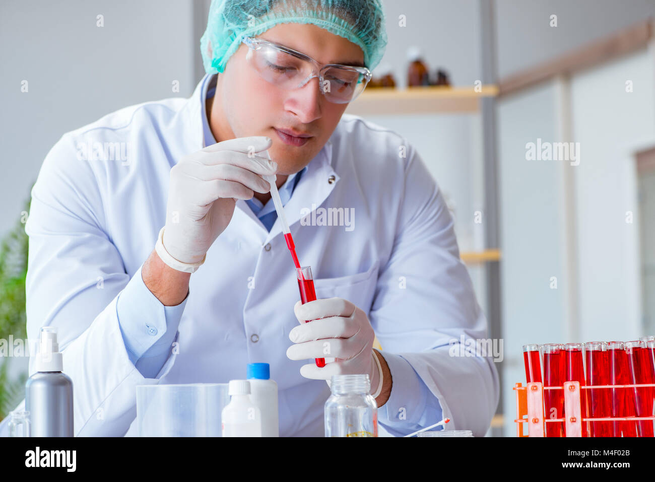 Young doctor working on blood test in lab hospital Stock Photo - Alamy