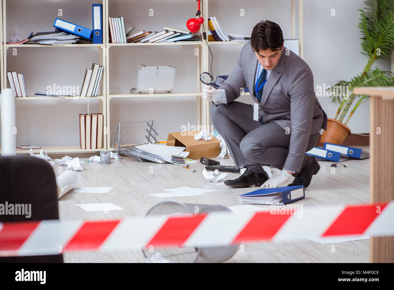Young man during crime investigation in office Stock Photo - Alamy