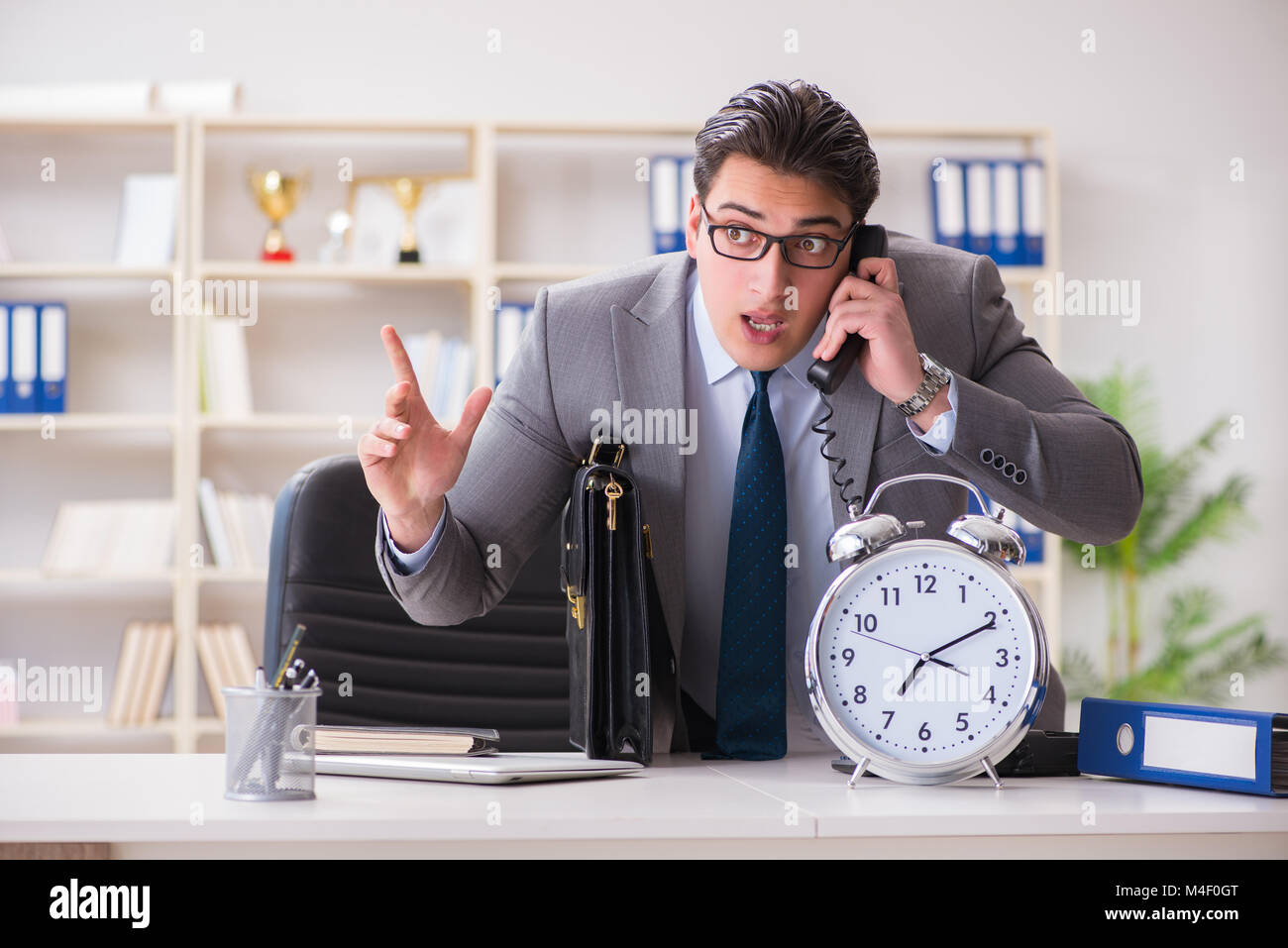 Businessman rushing in the office Stock Photo - Alamy