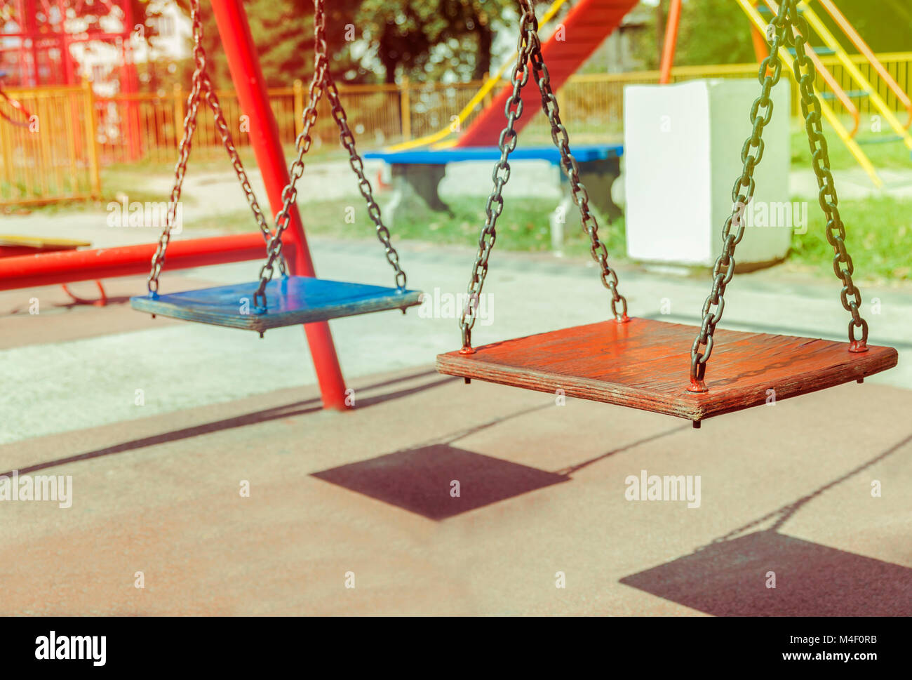 Empty chain swing in playground close Stock Photo - Alamy