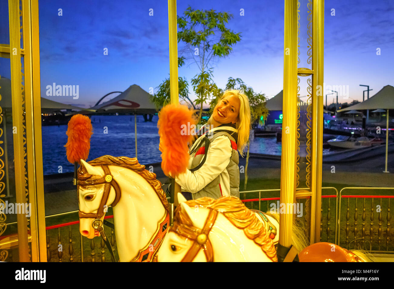 Woman riding carousel horse hi-res stock photography and images - Alamy