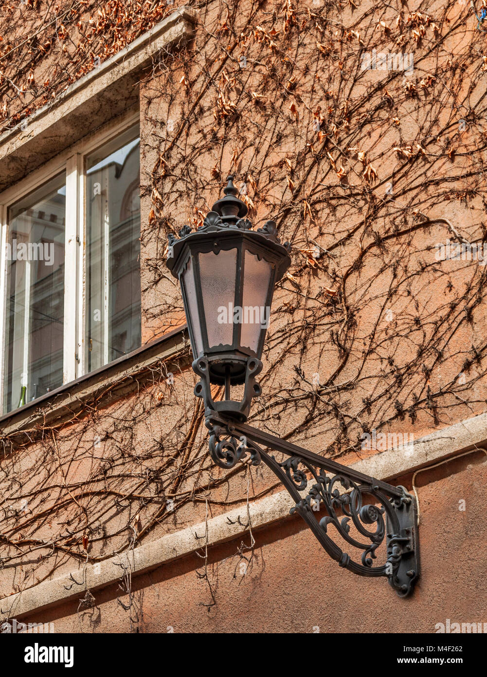 Old lantern on building street lamp Stock Photo - Alamy