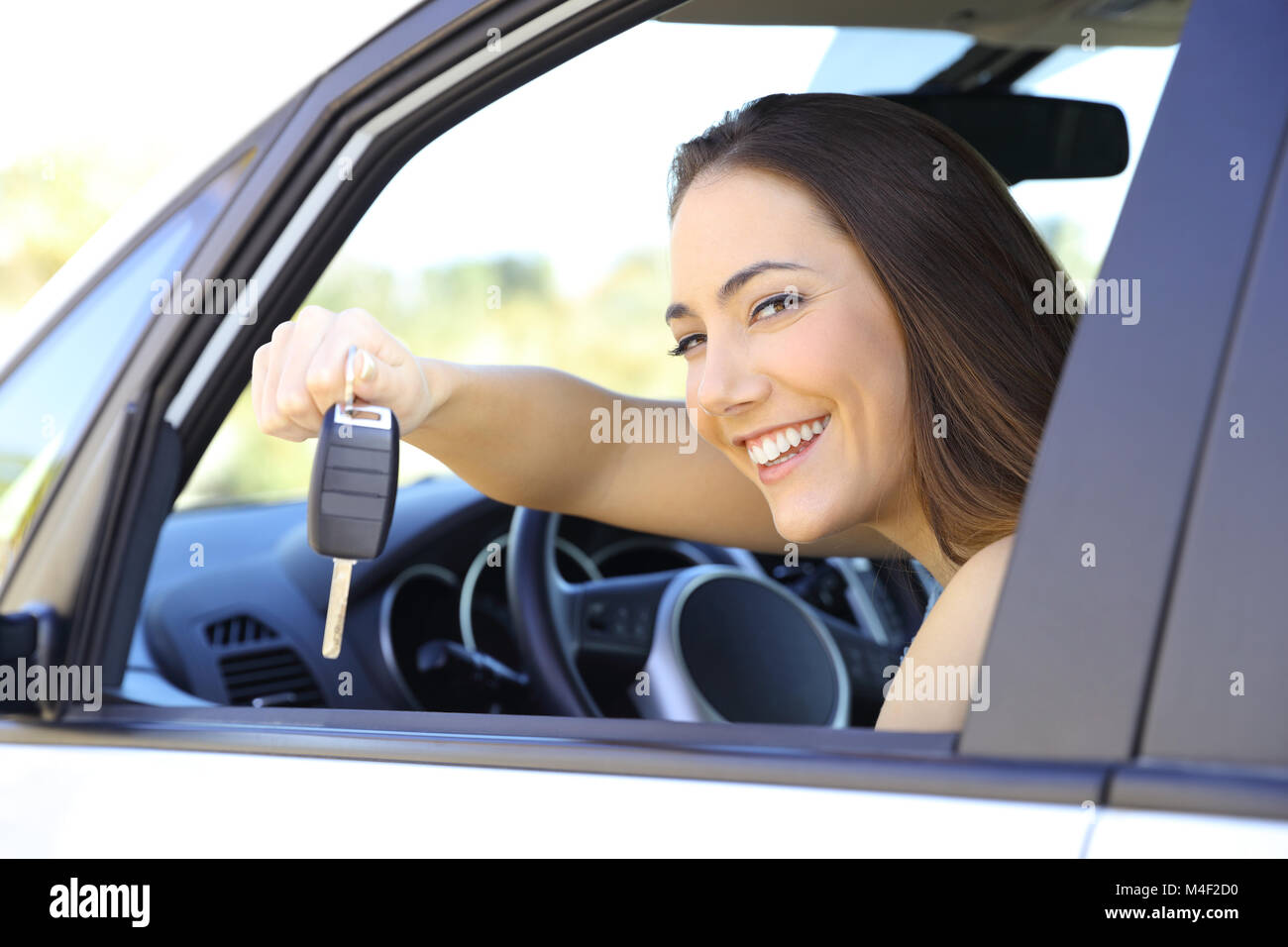 Satisfied driver showing the car keys to camera Stock Photo - Alamy