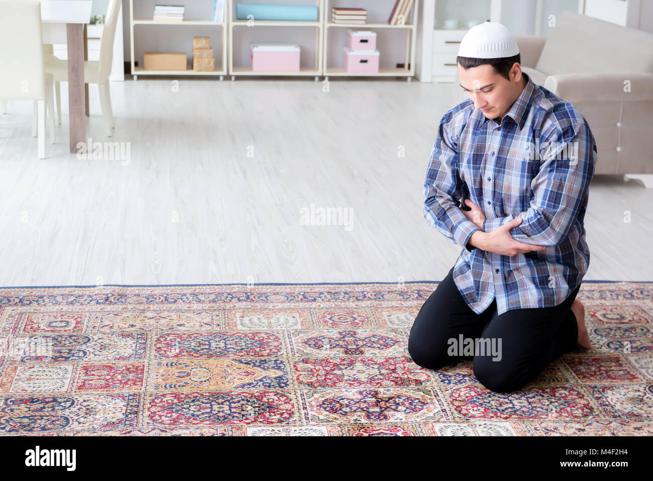 Muslim man praying at home Stock Photo - Alamy