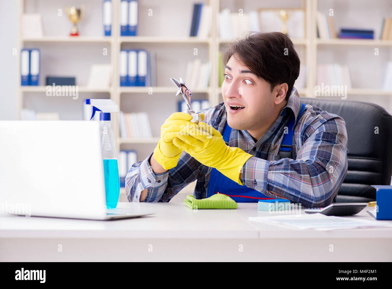 Male cleaner working in the office Stock Photo - Alamy