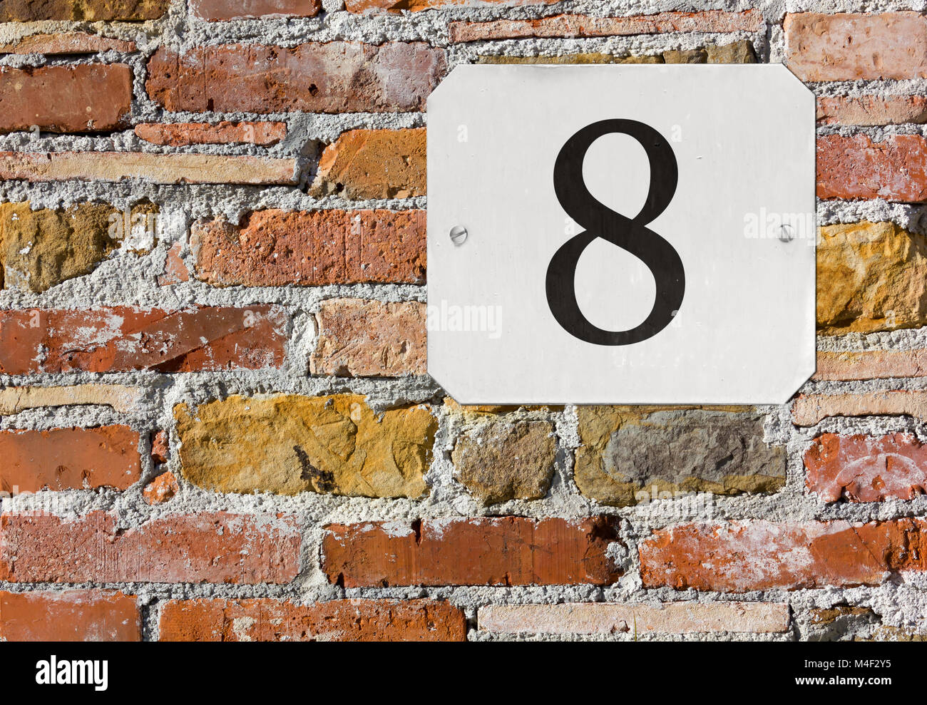 Number 8 street number sign on a brick wall Stock Photo - Alamy
