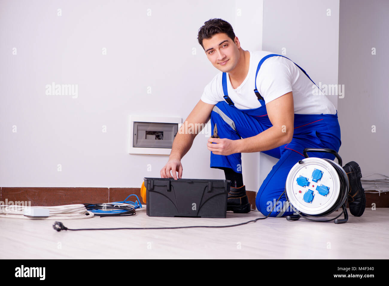 Man doing electrical repairs at home Stock Photo - Alamy