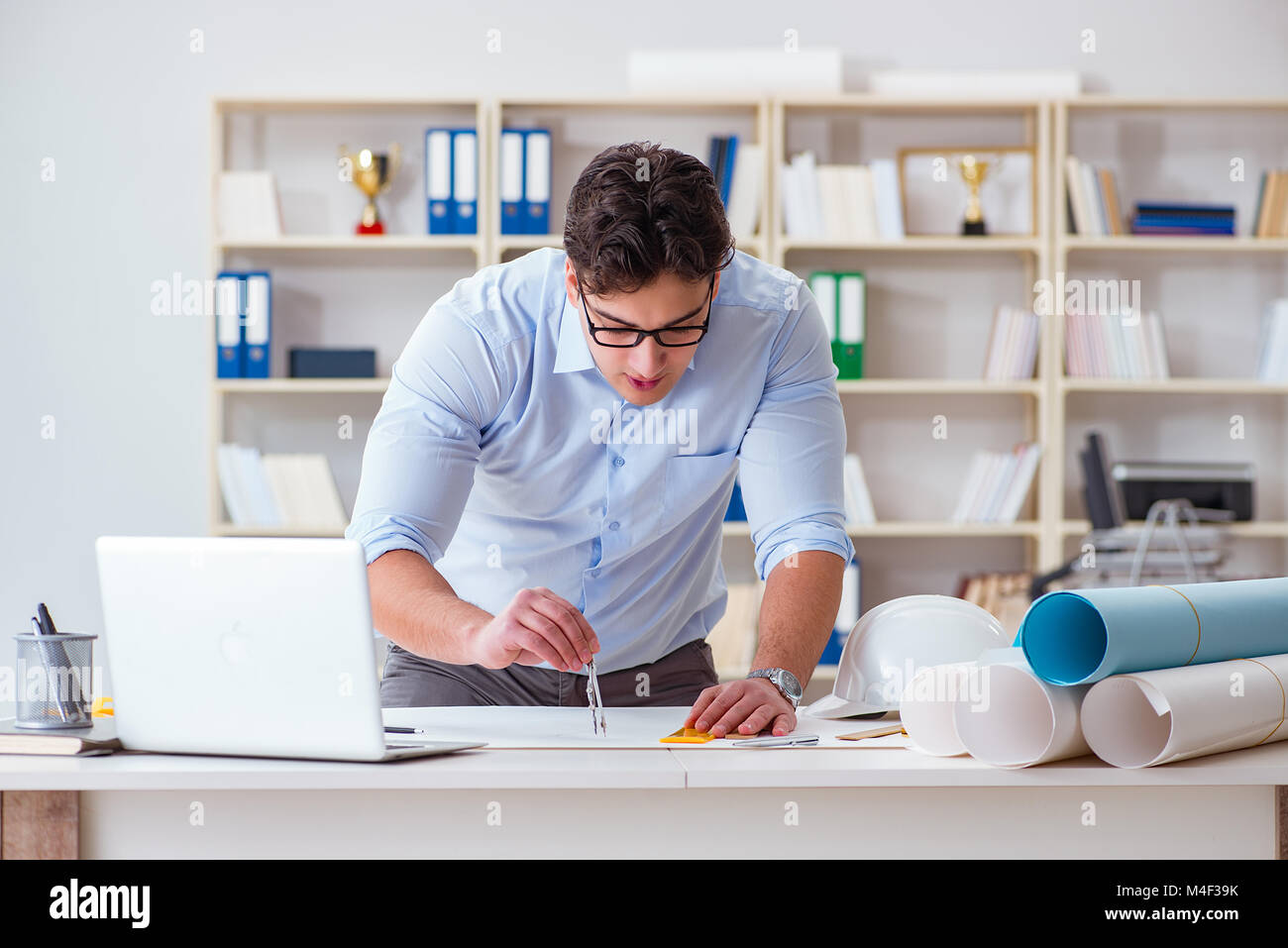 Male engineer working on drawings and blueprints Stock Photo - Alamy