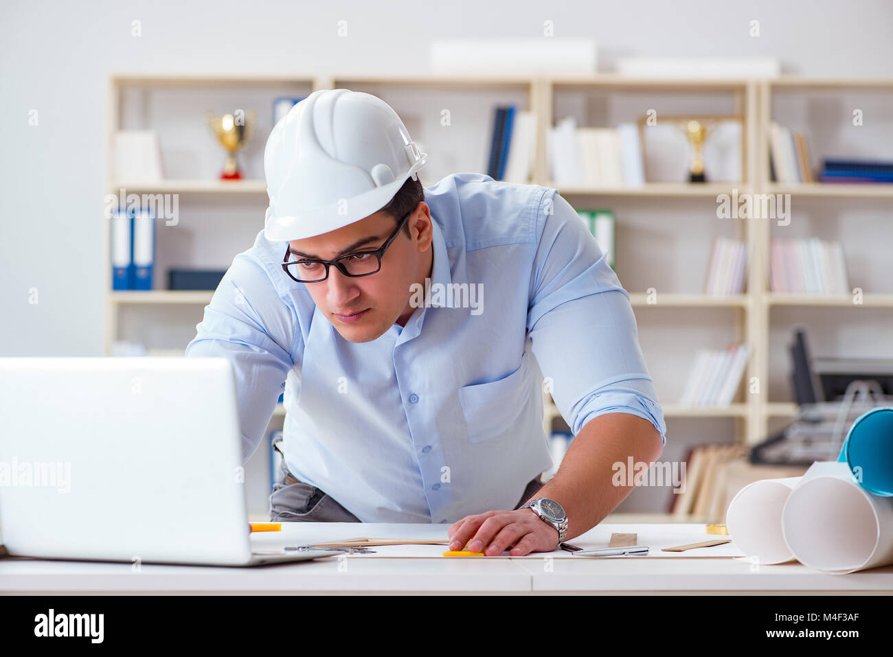 Male engineer working on drawings and blueprints Stock Photo - Alamy
