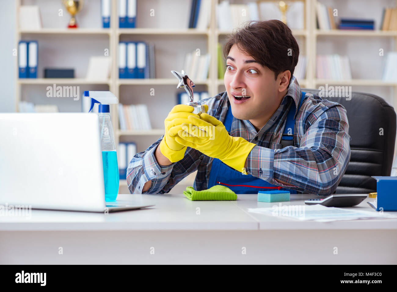 Male cleaner working in the office Stock Photo - Alamy