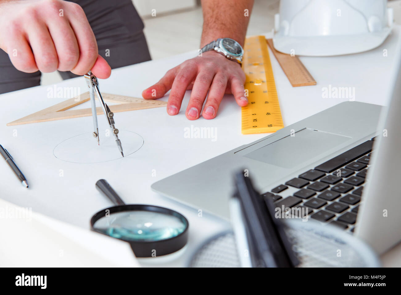 Male engineer working on drawings and blueprints Stock Photo - Alamy