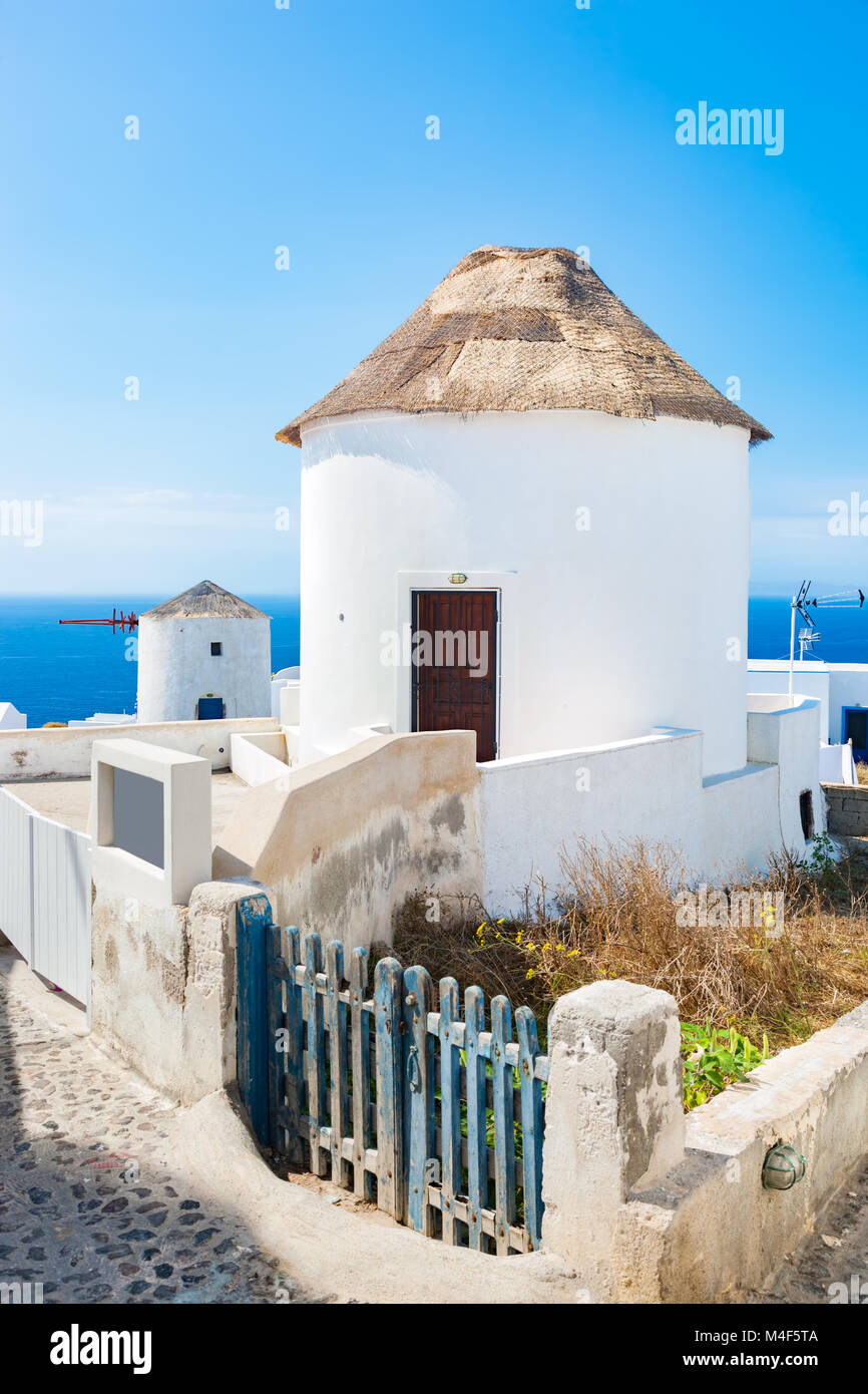 Famous windmills in Oia town on Santorini island, Greece Stock Photo ...