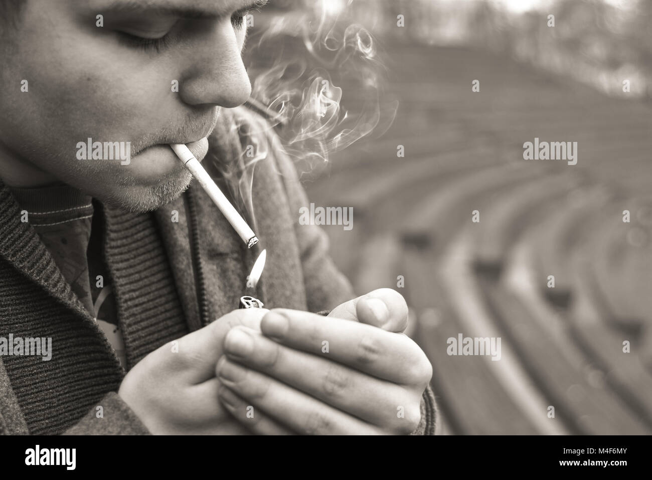 Guy smokes a cigarette outside, portrait, close-up Stock Photo - Alamy
