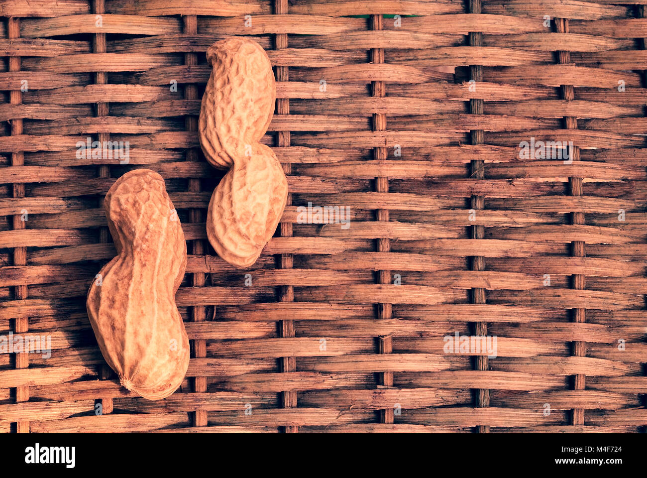 two peanuts with braided background, for title Stock Photo - Alamy