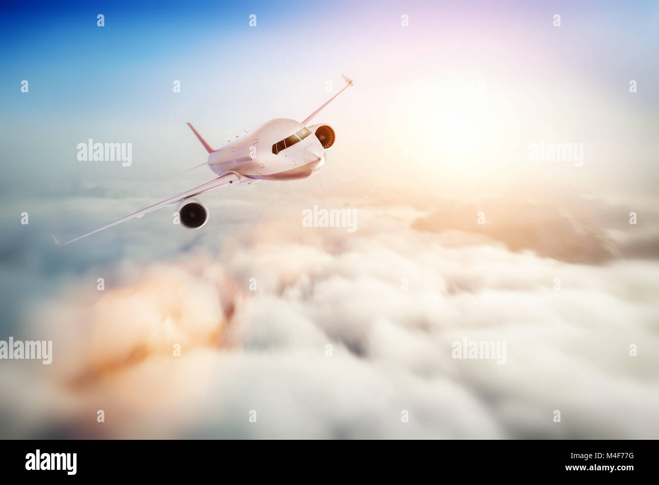 Passenger airplane flying at sunset, blue sky Stock Photo - Alamy