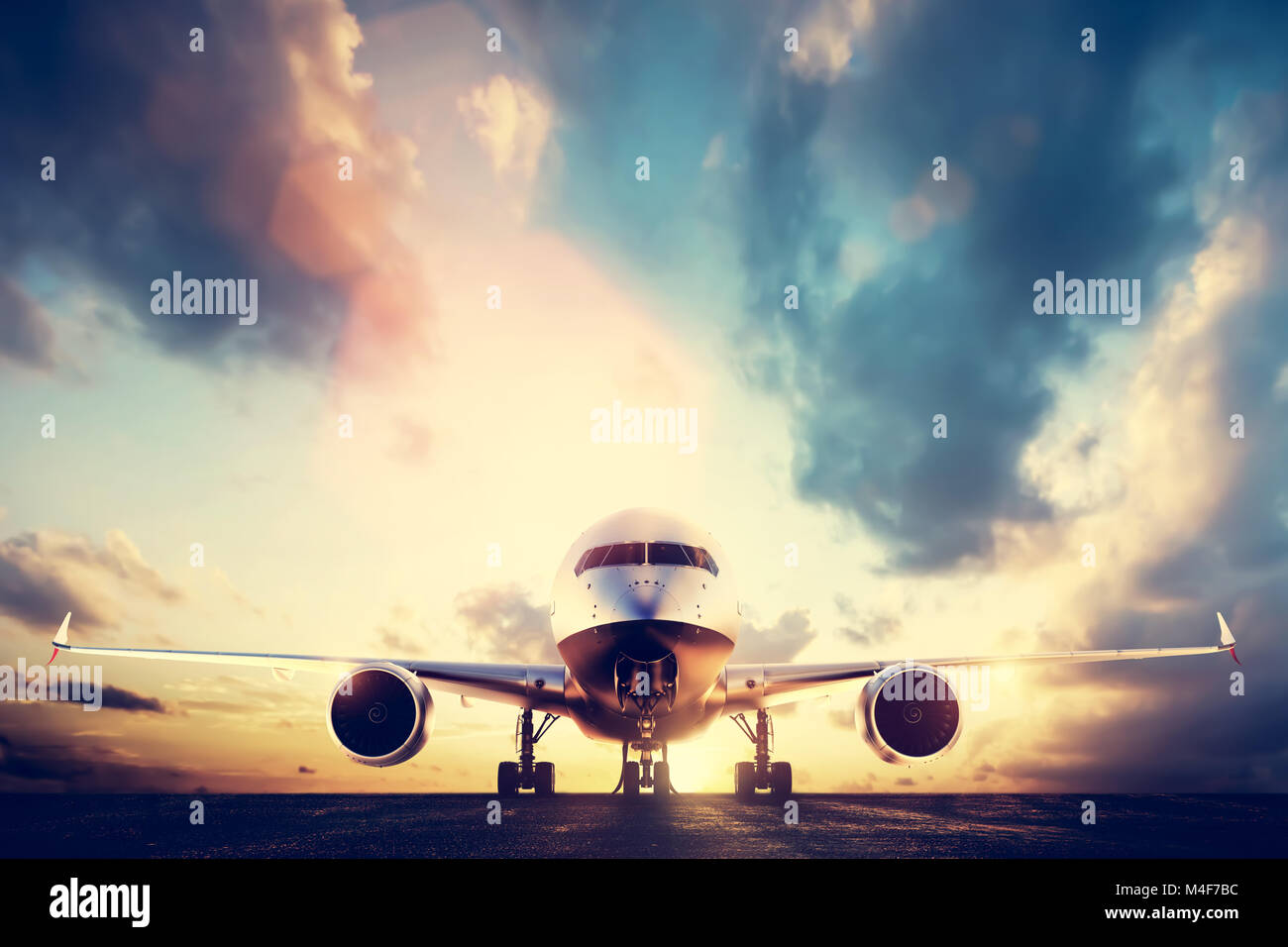 Passenger airplane taking off on runway at sunset Stock Photo - Alamy