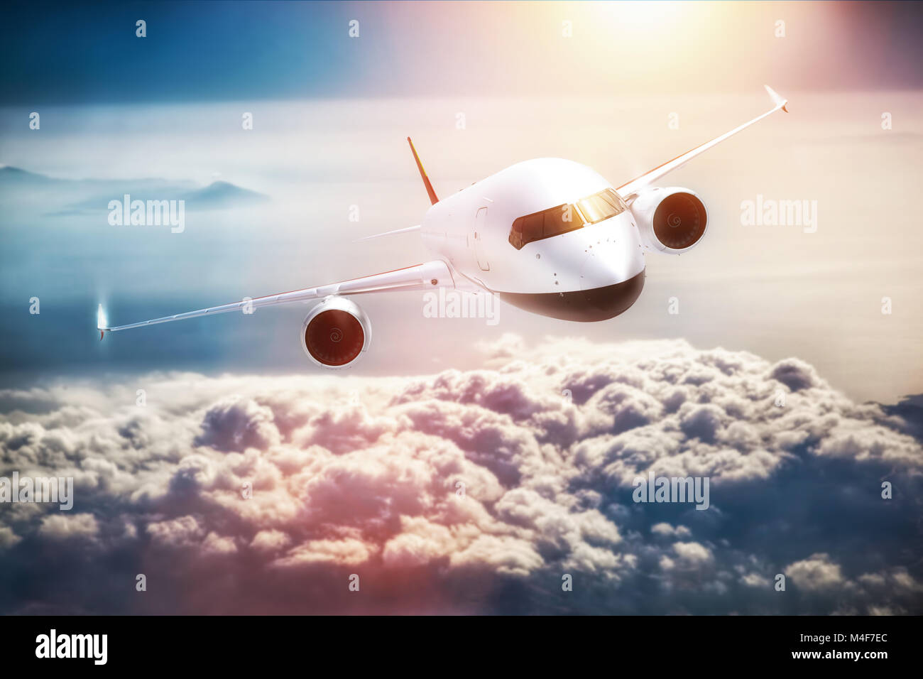 Passenger airplane flying at sunset, blue sky Stock Photo - Alamy