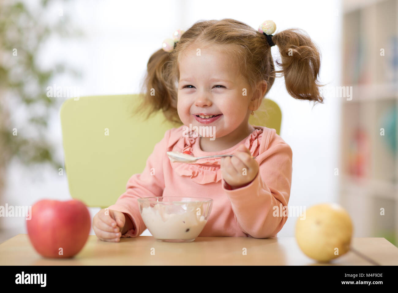 child eating healthy food with the left hand at home Stock Photo - Alamy
