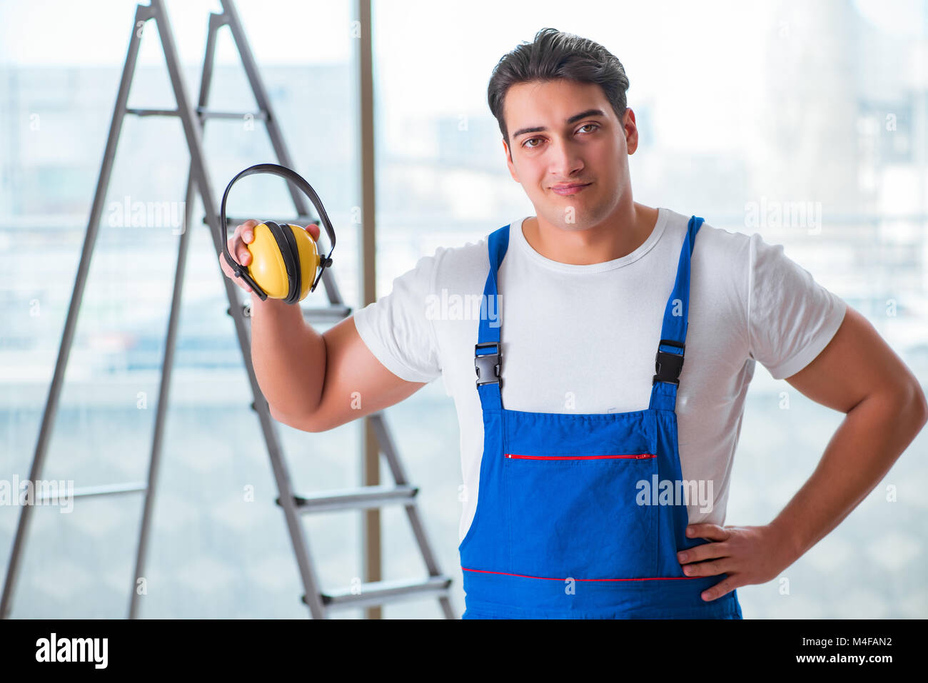 Worker with noise cancelling headphones Stock Photo - Alamy