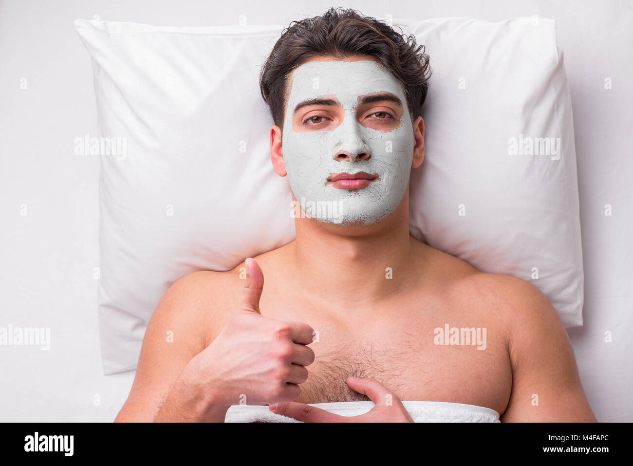 Handsome man in spa massage concept Stock Photo - Alamy