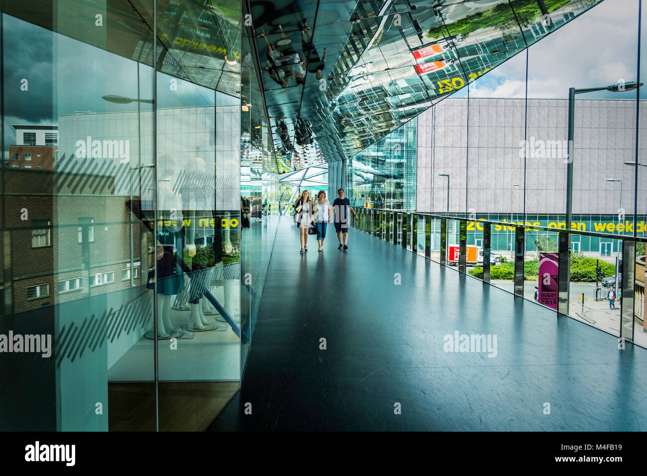 Glass walled pedestrian walkway at a shopping centre Stock Photo - Alamy