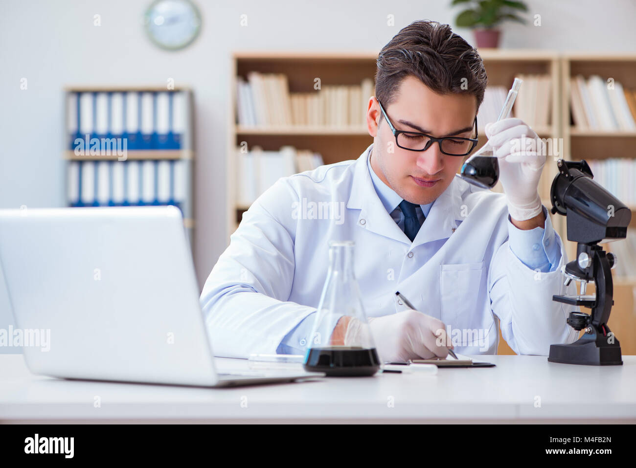 Chemical engineer working on oil samples in lab Stock Photo - Alamy