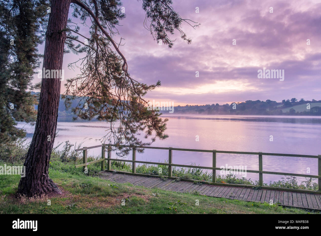 View across Thornton Reservoir at dawn Stock Photo - Alamy