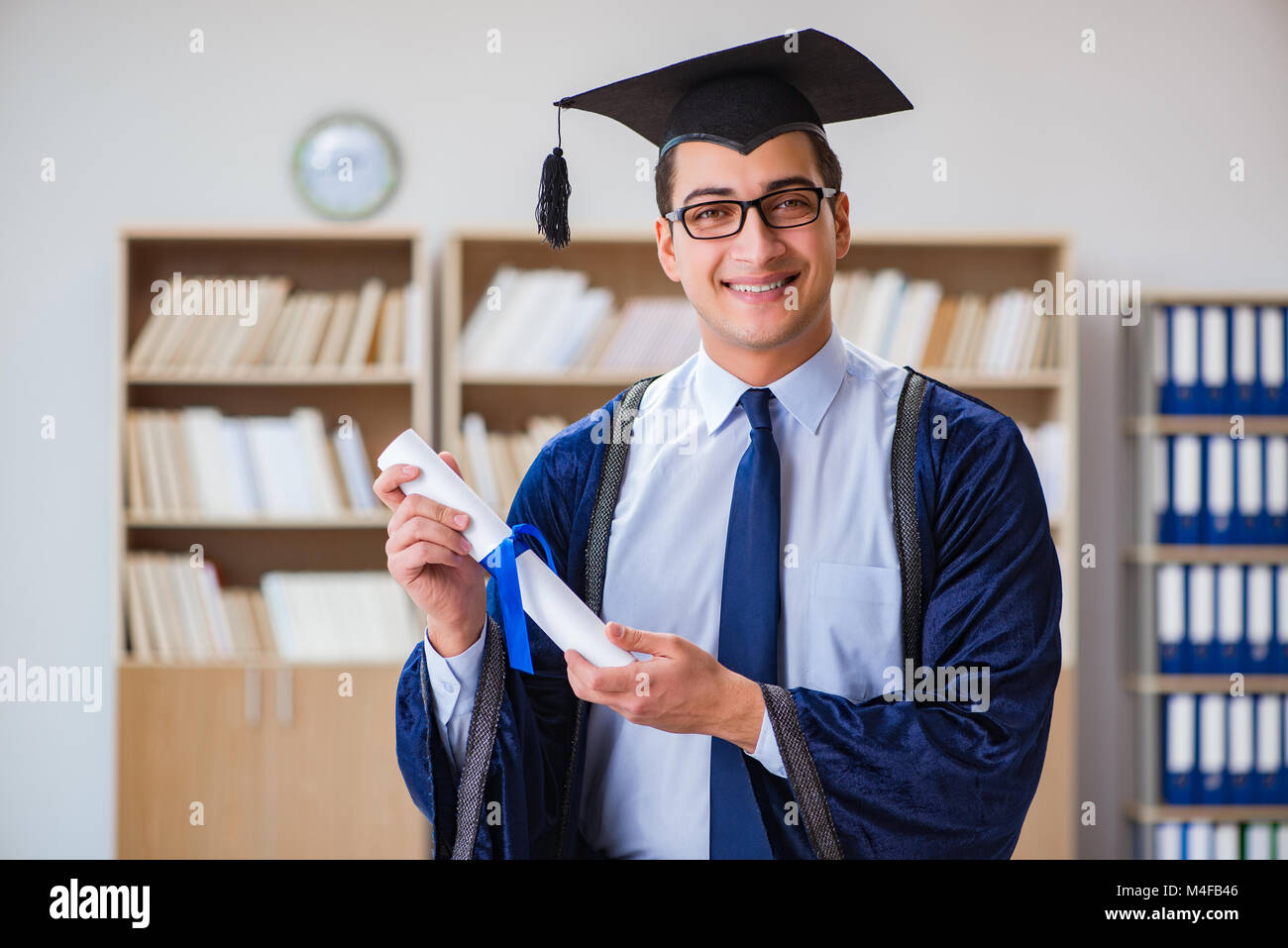 Young man graduating from university Stock Photo - Alamy
