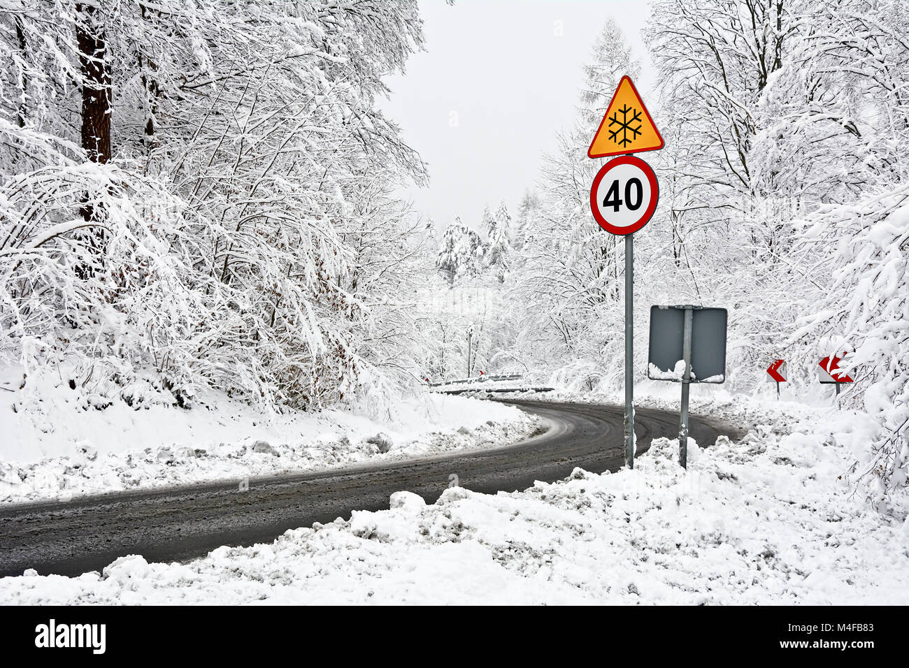 Snow covered road with traffic sign hi-res stock photography and images ...