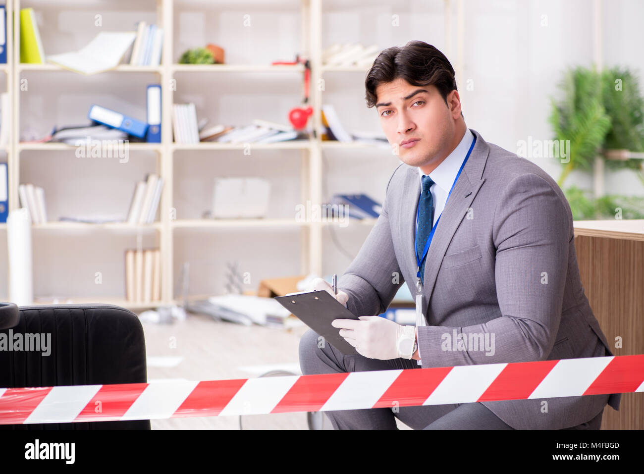 Young man during crime investigation in office Stock Photo - Alamy