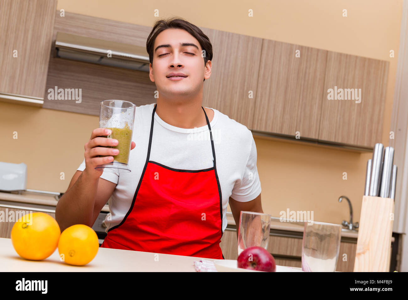 Handsome man working at the kitchen Stock Photo - Alamy