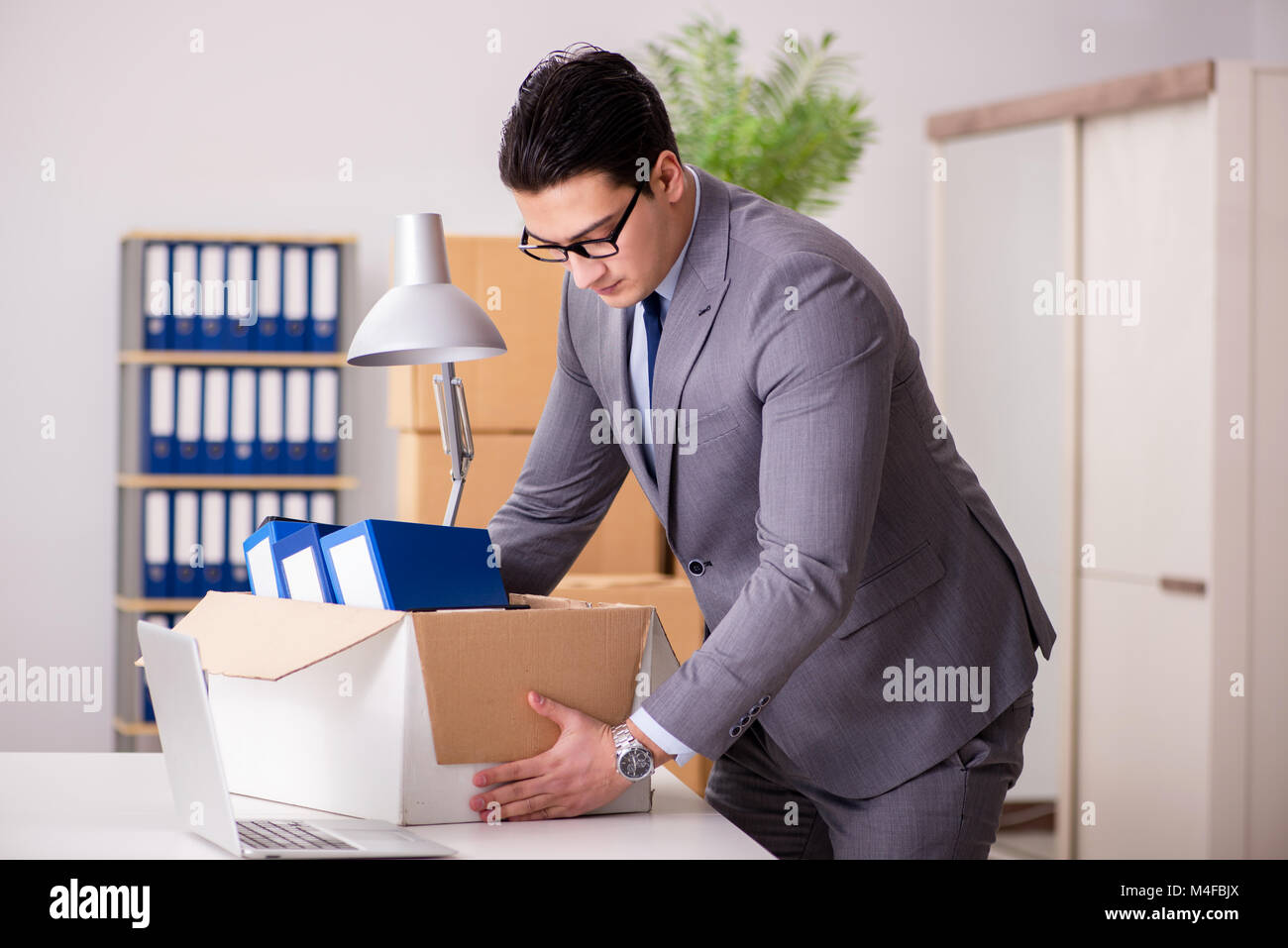 Young man moving offices hi-res stock photography and images - Alamy