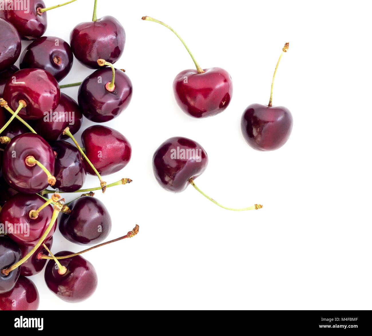 Ripe cherries isolated on white background. Top view Stock Photo - Alamy