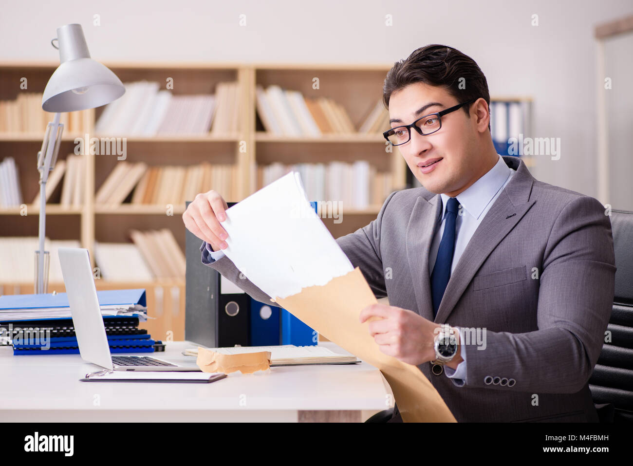 Businessman receiving letter in the office Stock Photo - Alamy