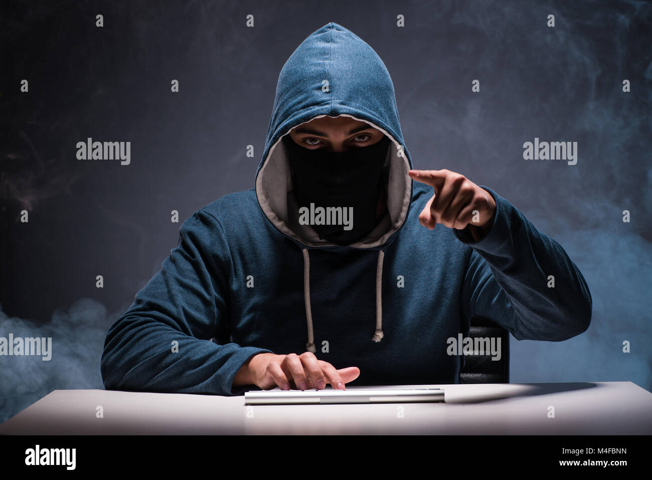 Computer hacker working in dark room Stock Photo - Alamy