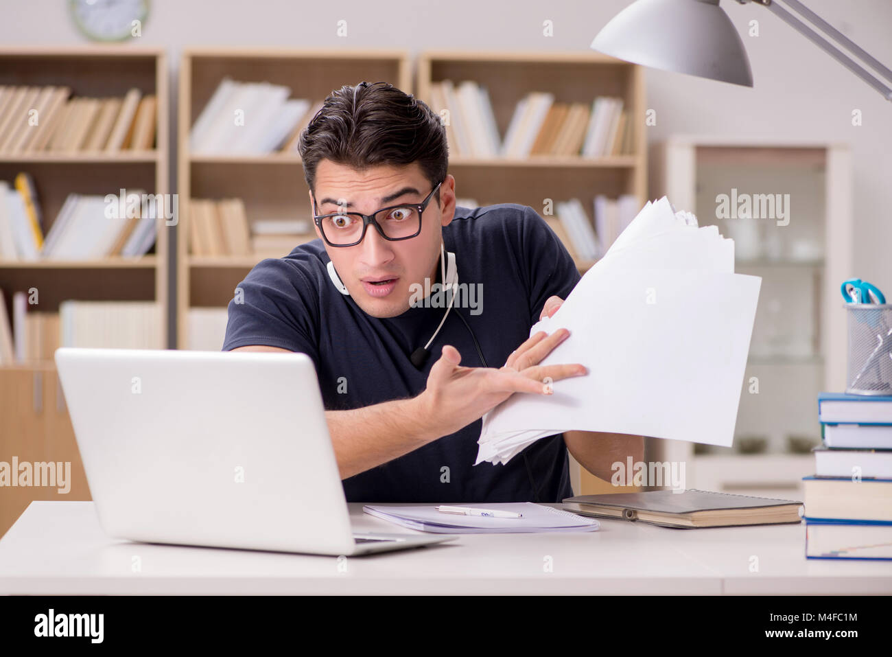 Angry man with too much paperwork to do Stock Photo - Alamy