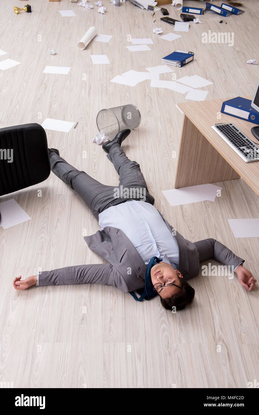 Businessman dead on the office floor Stock Photo - Alamy
