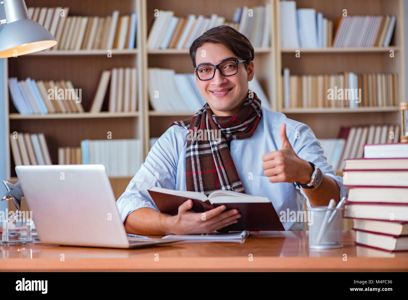 Young book writer writing in library Stock Photo - Alamy