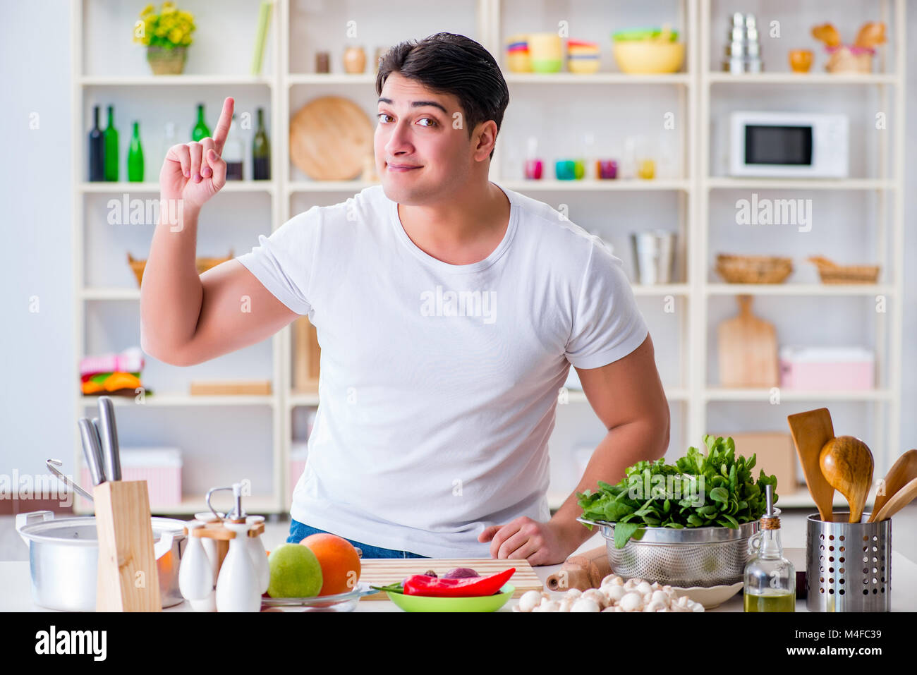 Young male cook working in the kitchen Stock Photo - Alamy