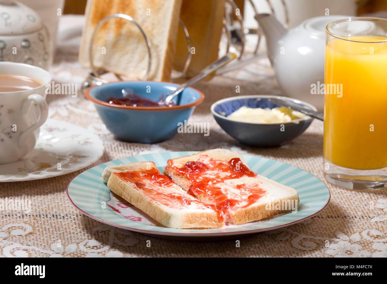 Breakfast settings with toast jam and butter Stock Photo - Alamy