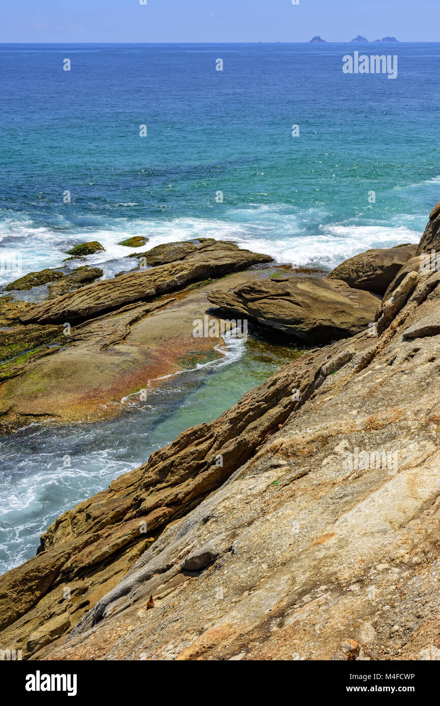 Blue water and rocks Stock Photo - Alamy