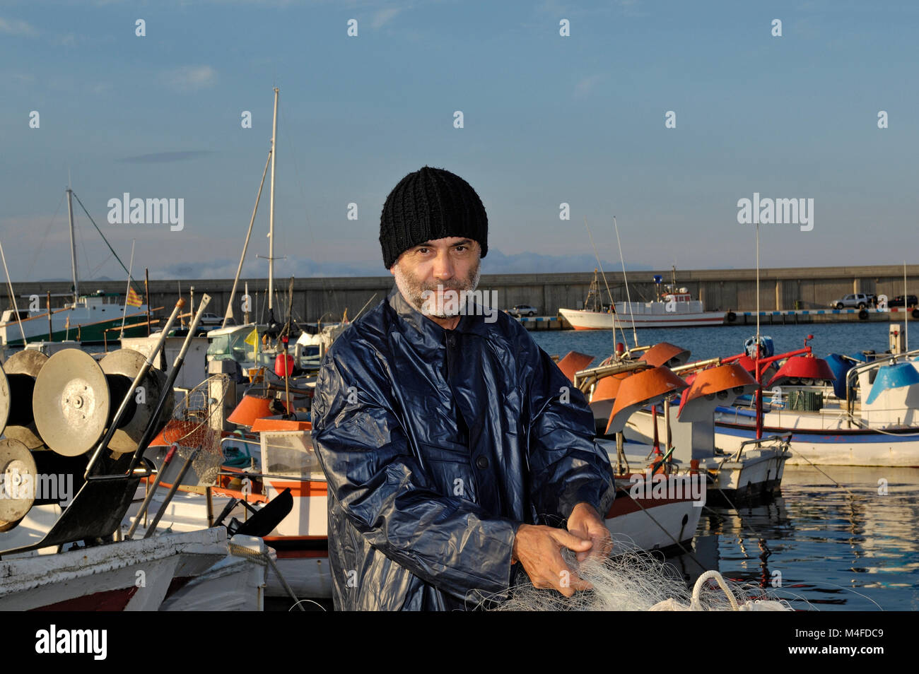 fisherman working in the fishing port Stock Photo - Alamy