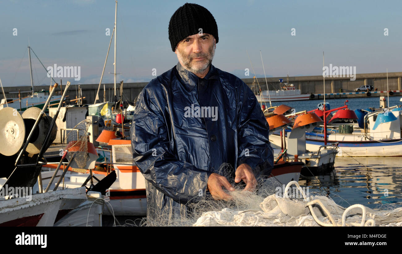 fisherman working in the fishing port Stock Photo - Alamy